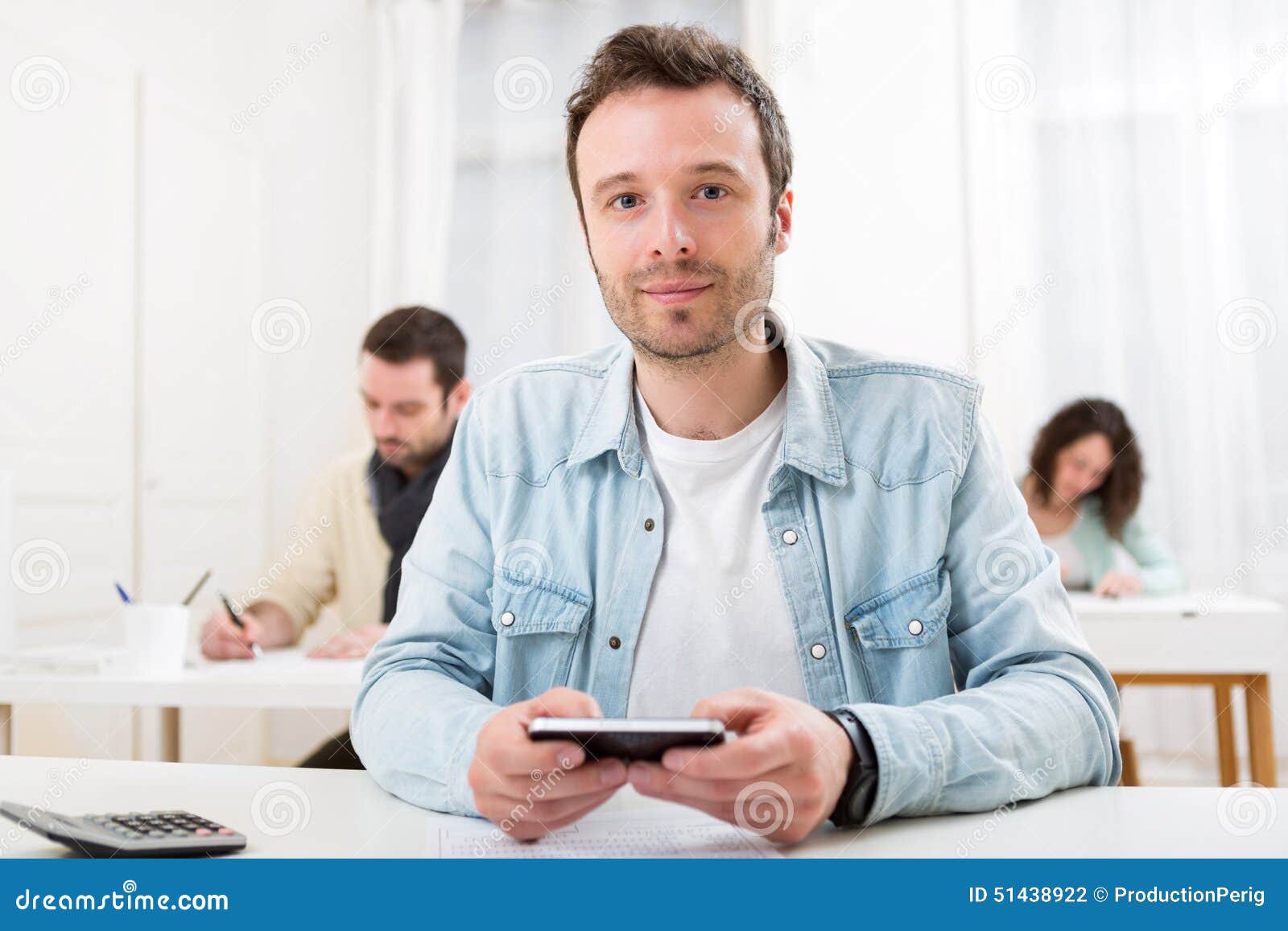 Young Attractive Student Using His Mobile during Classes Stock Photo ...