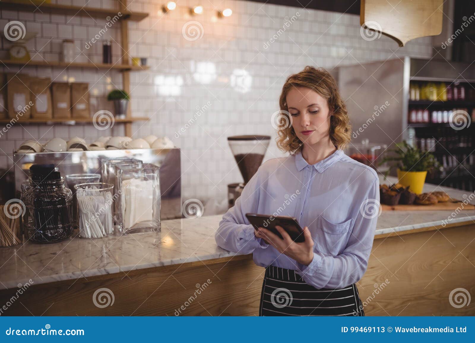 Young Attractive Waitress Using Digital Tablet while Standing by ...