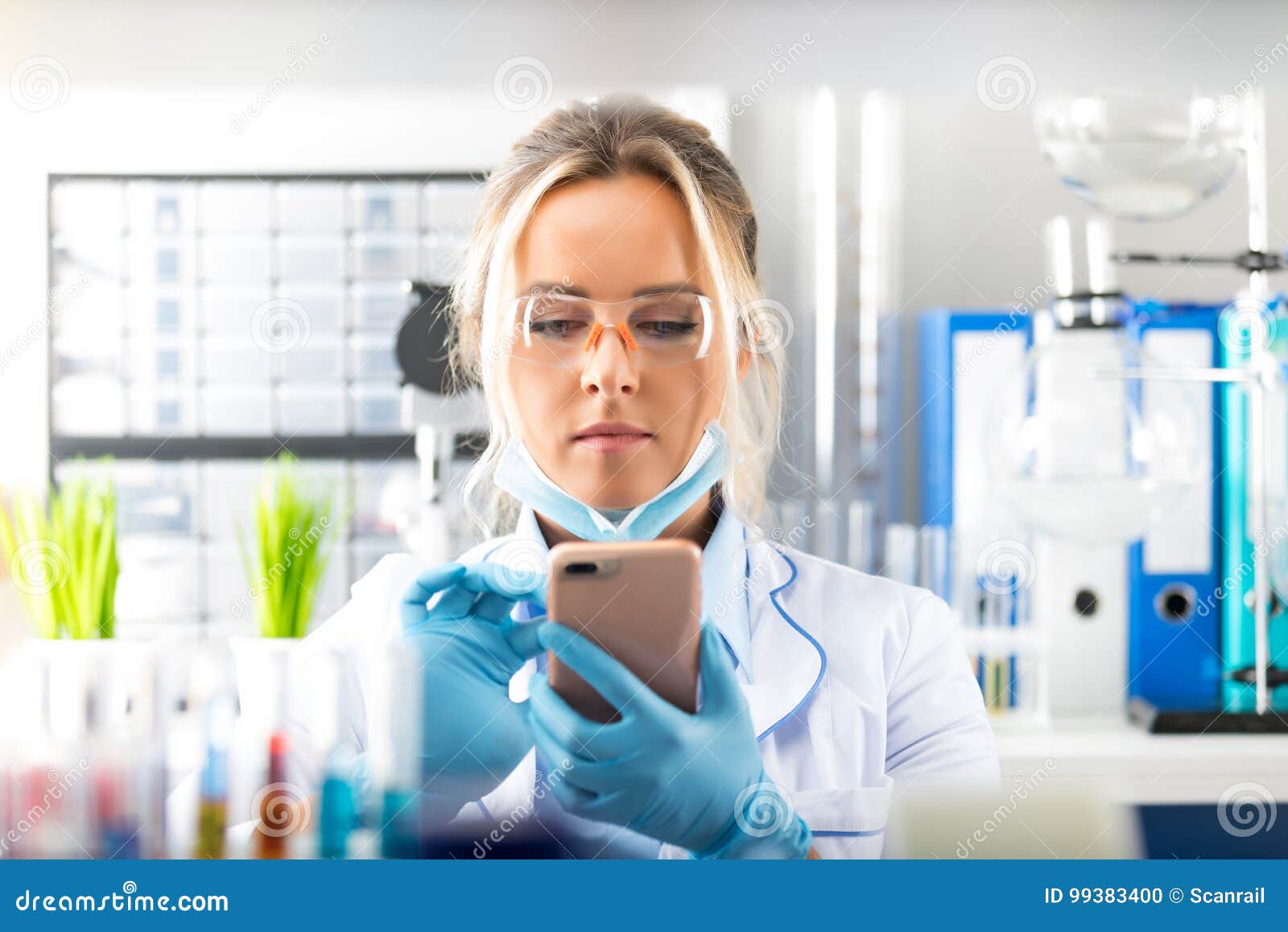 Young Attractive Woman Scientist Using Smartphone in the Laboratory ... Young Attractive Woman Scientist Using Smartphone in the Laboratory ...