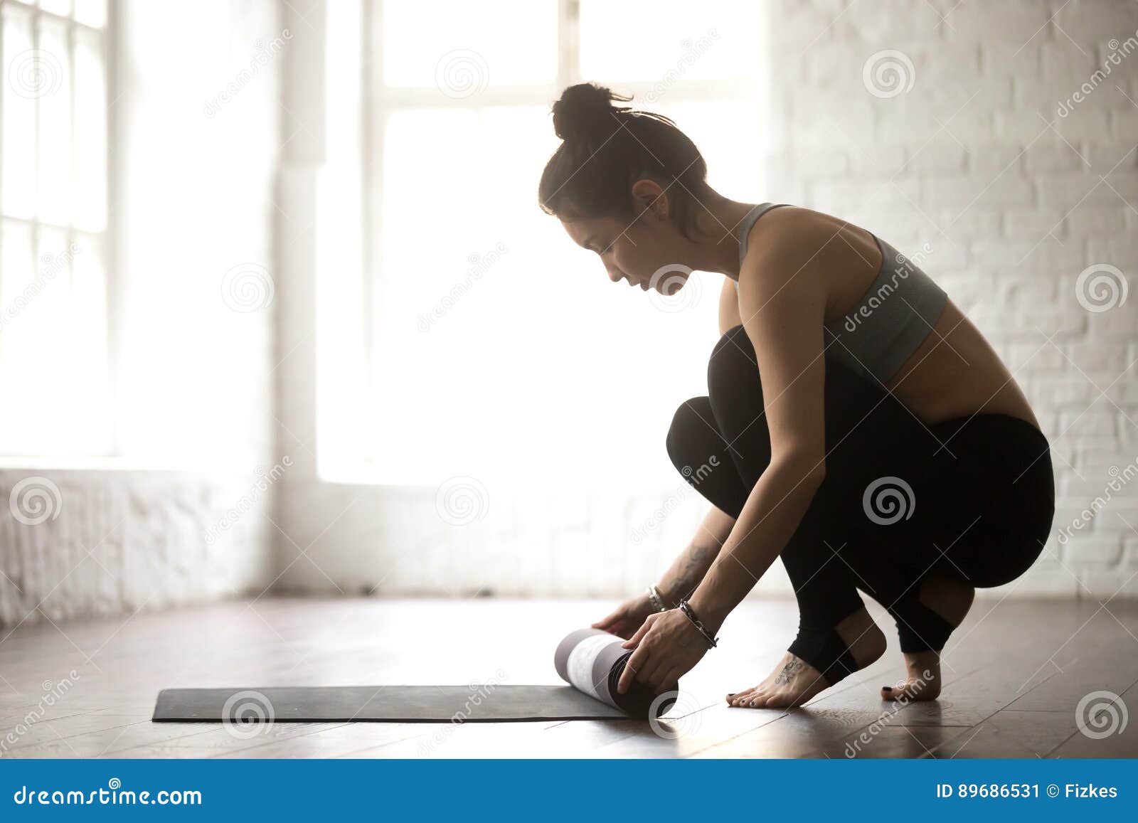 Young Attractive Woman Unrolling Yoga Mat, White Loft Studio Bac Stock ...