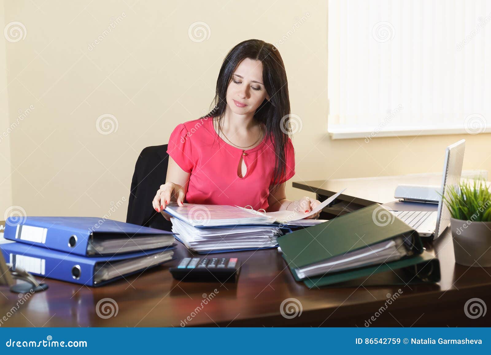 Young Attractive Woman Working with Documents in the Folders at the ...