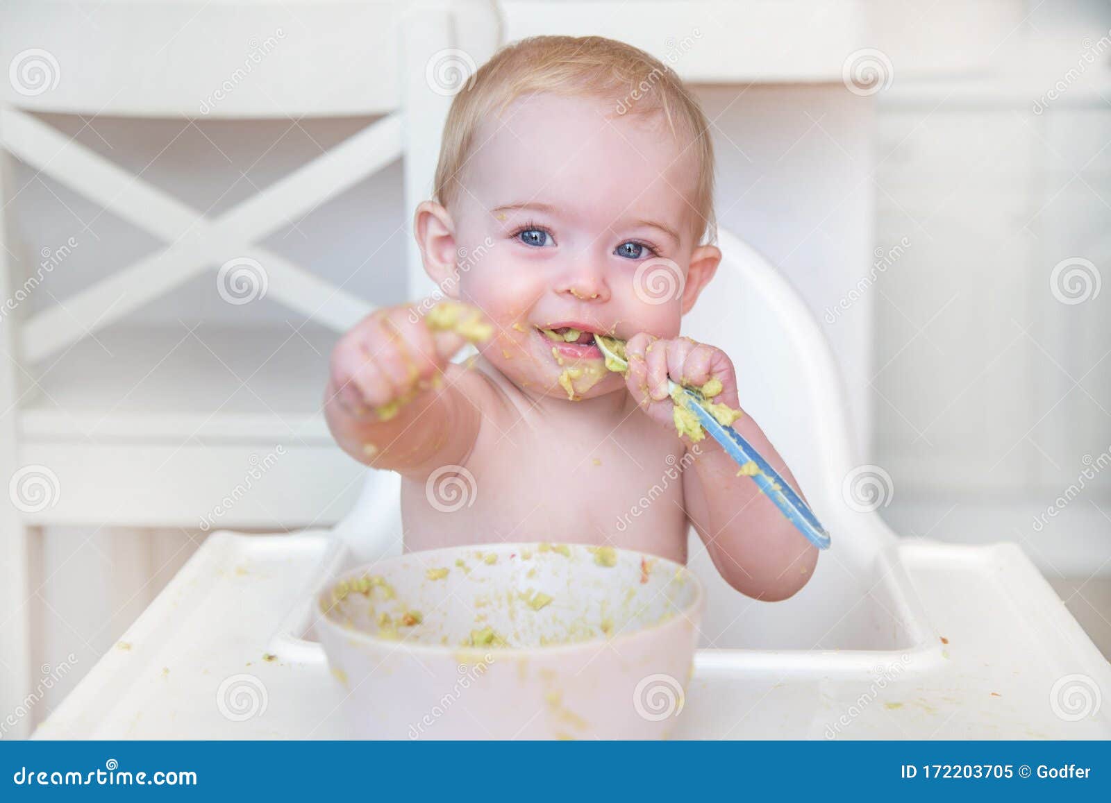 Baby Eating First Solid Food Stock Image - Image of making, healthy ...