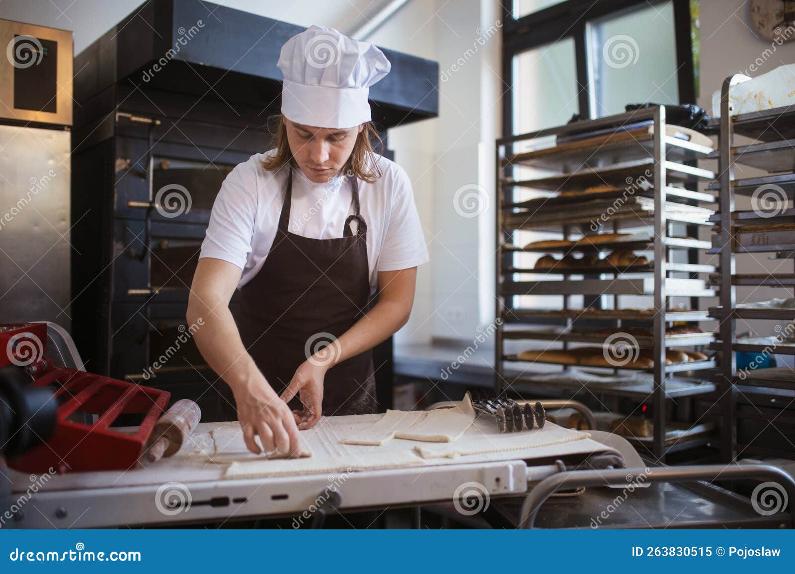 Young Baker with Chef Cap Preparing Pastries in Bakery. Stock Image ...
