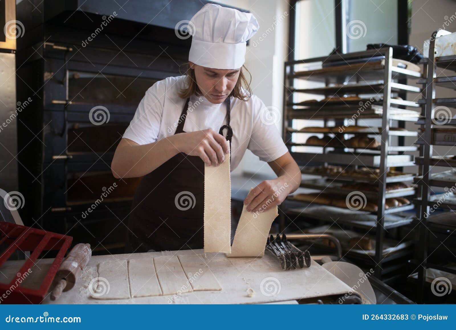 Young Baker with Chef Cap Preparing Pastries in Bakery. Stock Image ...
