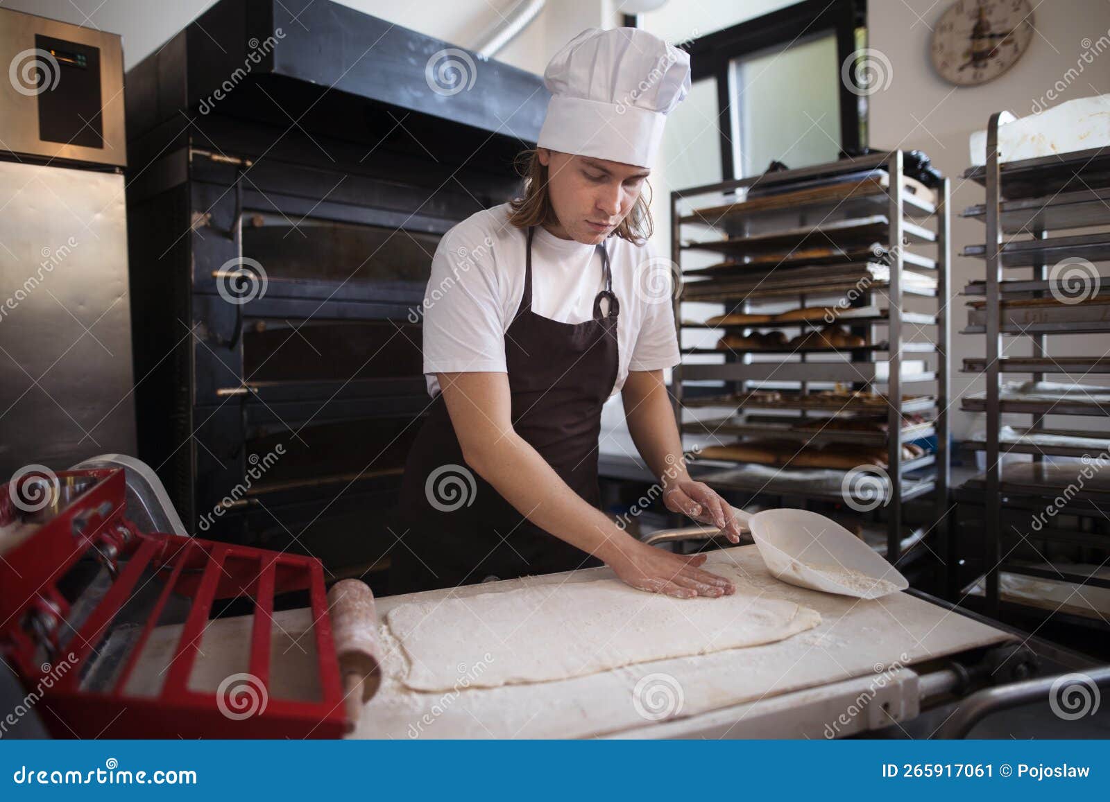 Young Baker with Chef Cap Preparing Pastries in Bakery. Stock Image ...