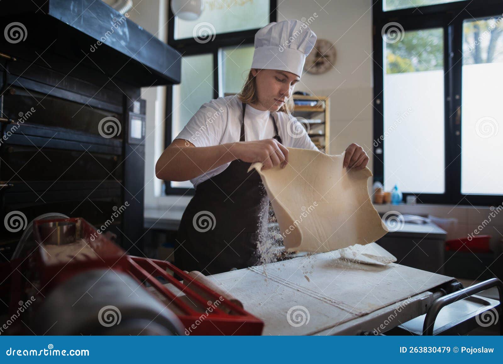 Young Baker with Chef Cap Preparing Pastries in Bakery. Stock Image ...