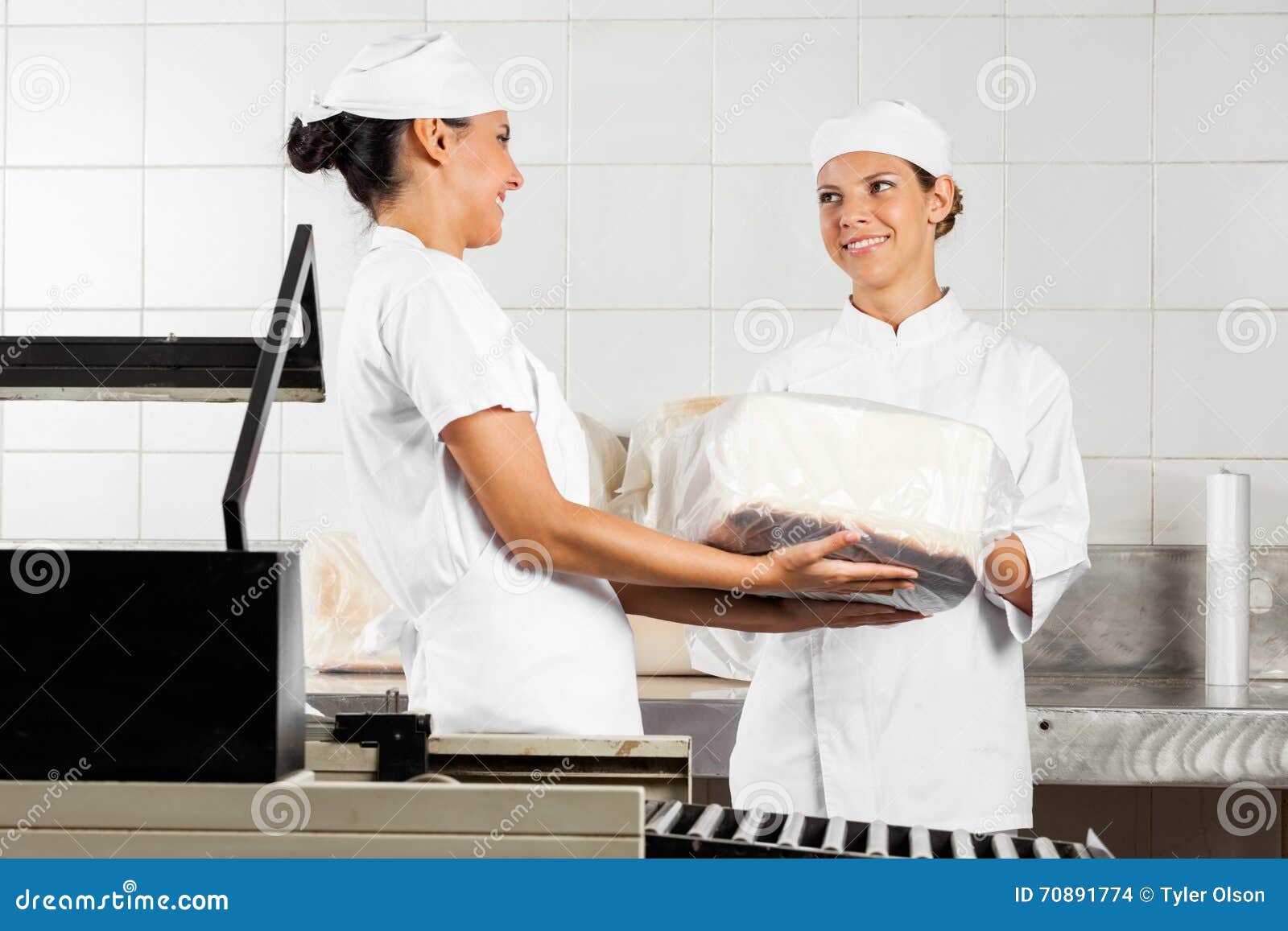 Young Baker S Looking at Each Other while Packing Breads Stock Photo ...