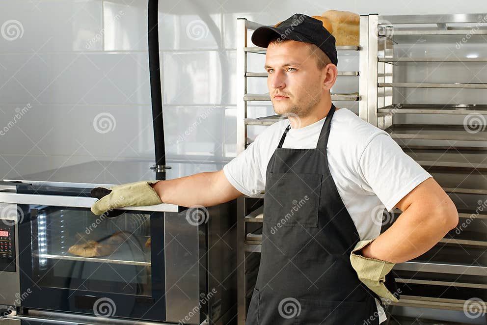 Young Baker Worker in a Bakery in Uniform Stock Photo - Image of ...