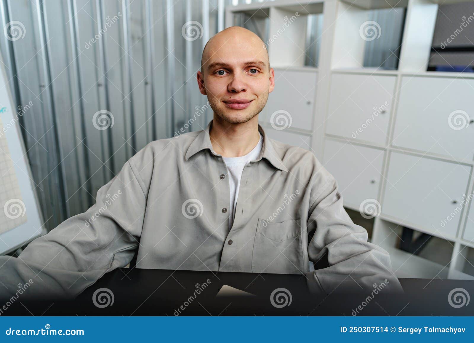 Young Bald Business Man Sitting at Desk in Office, Working on Computer ...