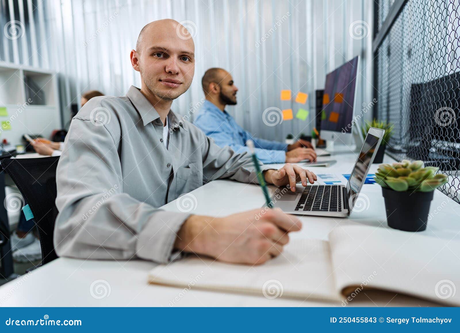 Young Bald Business Man Sitting at Desk in Office, Working on Computer ...