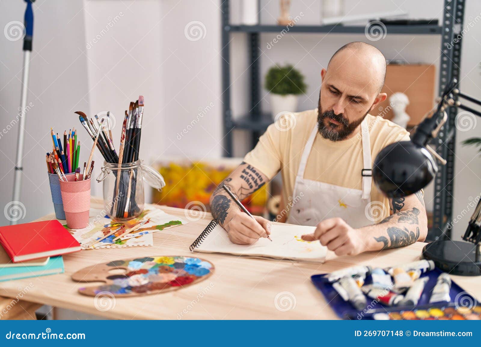 Young Bald Man Artist Drawing on Notebook at Art Studio Stock Photo ...