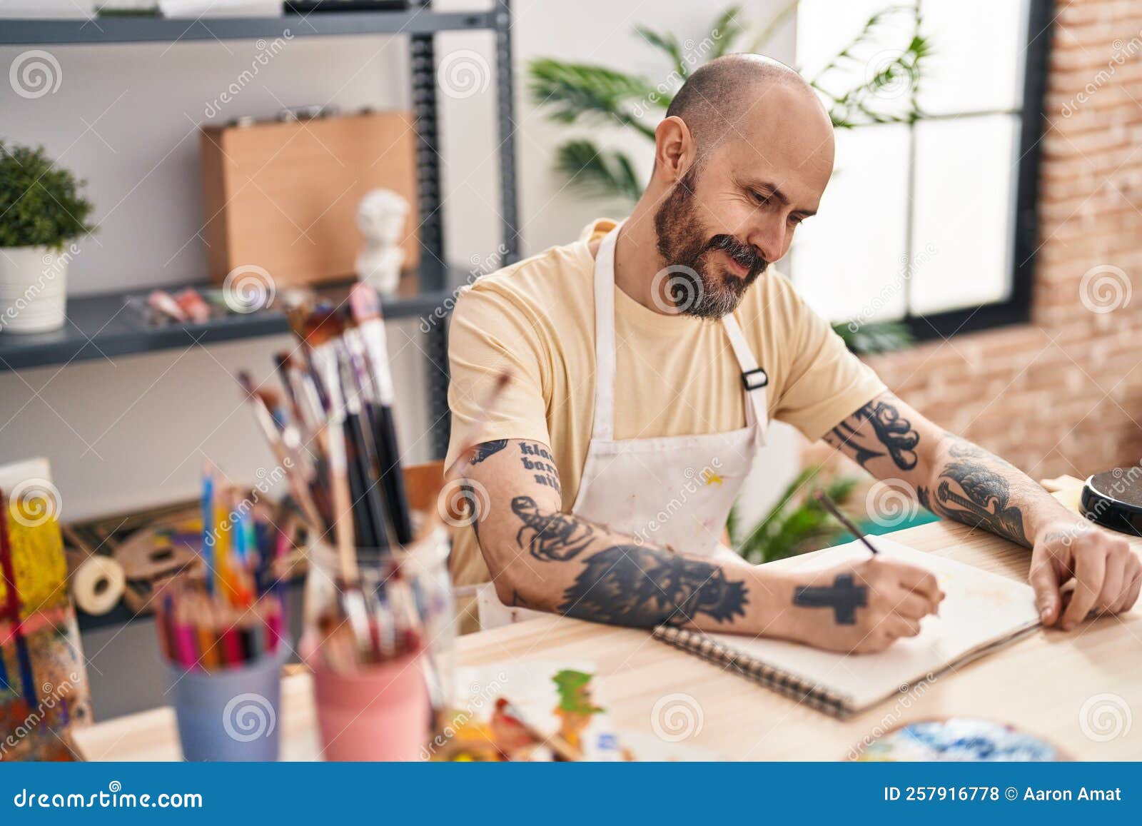 Young Bald Man Artist Smiling Confident Drawing on Notebook at Art ...