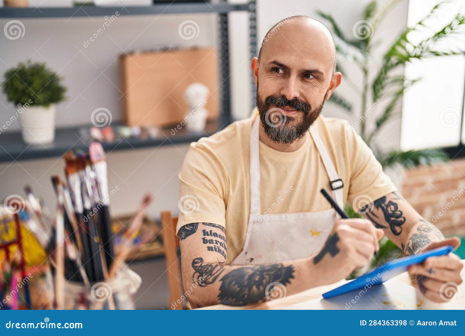 Young Bald Man Artist Smiling Confident Drawing on Touchpad at Art ...