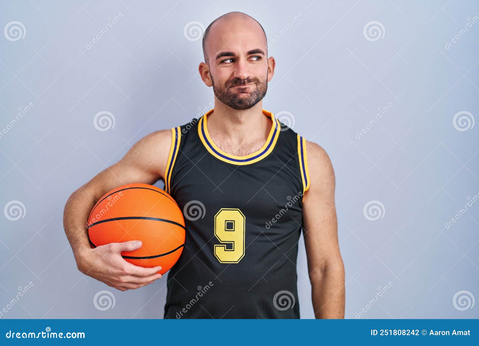 Young Bald Man with Beard Wearing Basketball Uniform Holding Ball ... Young Bald Man with Beard Wearing Basketball Uniform Holding Ball ...
