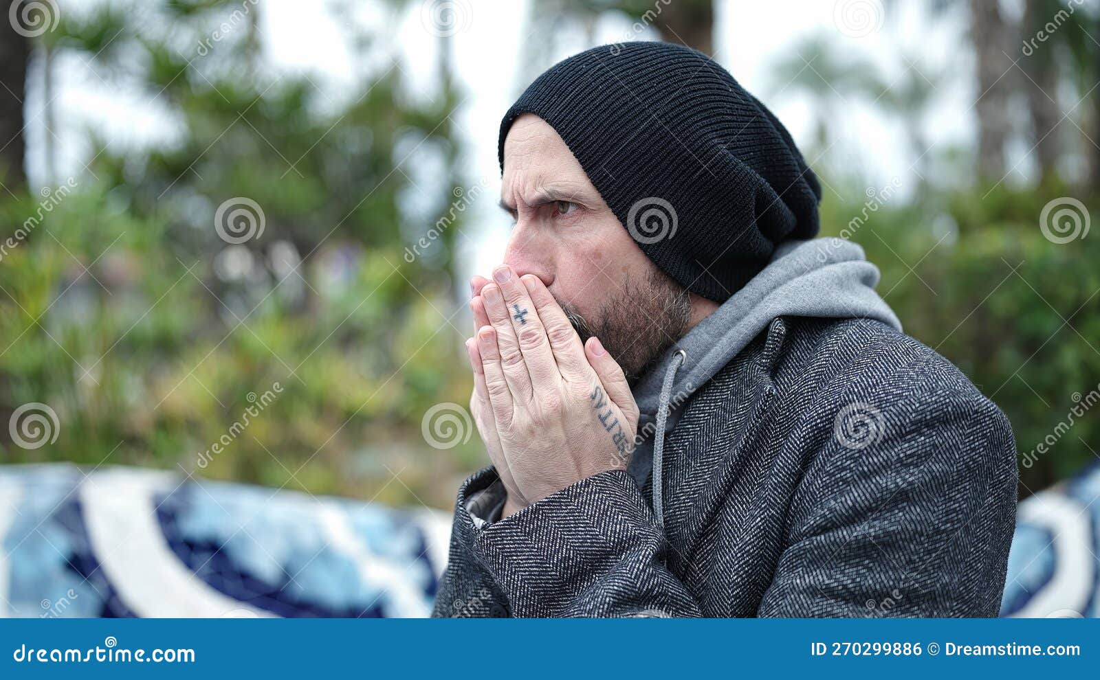 Young Bald Man Blowing Hot Air on Hands for Cold at Park Stock Photo ...