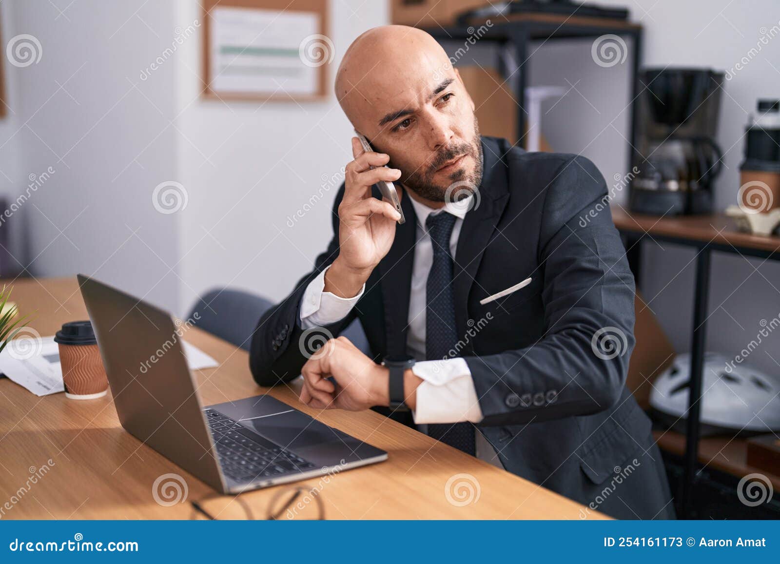 Young Bald Man Business Worker Talking on Smartphone Looking Watch at ...