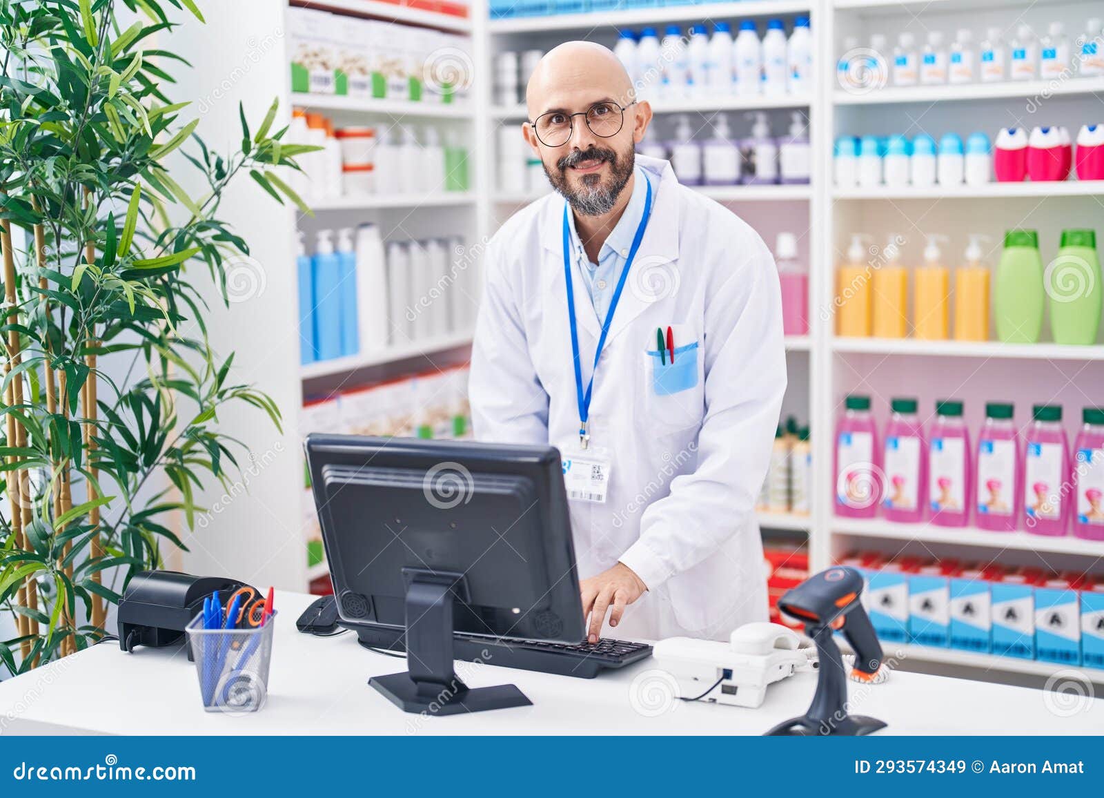 Young Bald Man Pharmacist Smiling Confident Using Computer at Pharmacy ...
