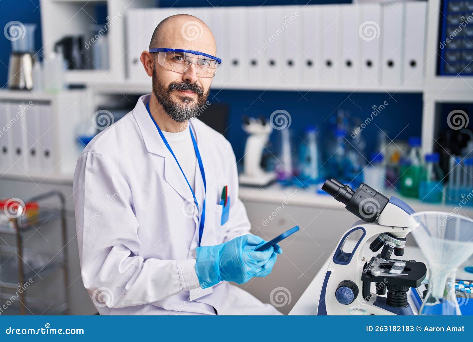 Young Bald Man Scientist Smiling Confident Using Smartphone at ...