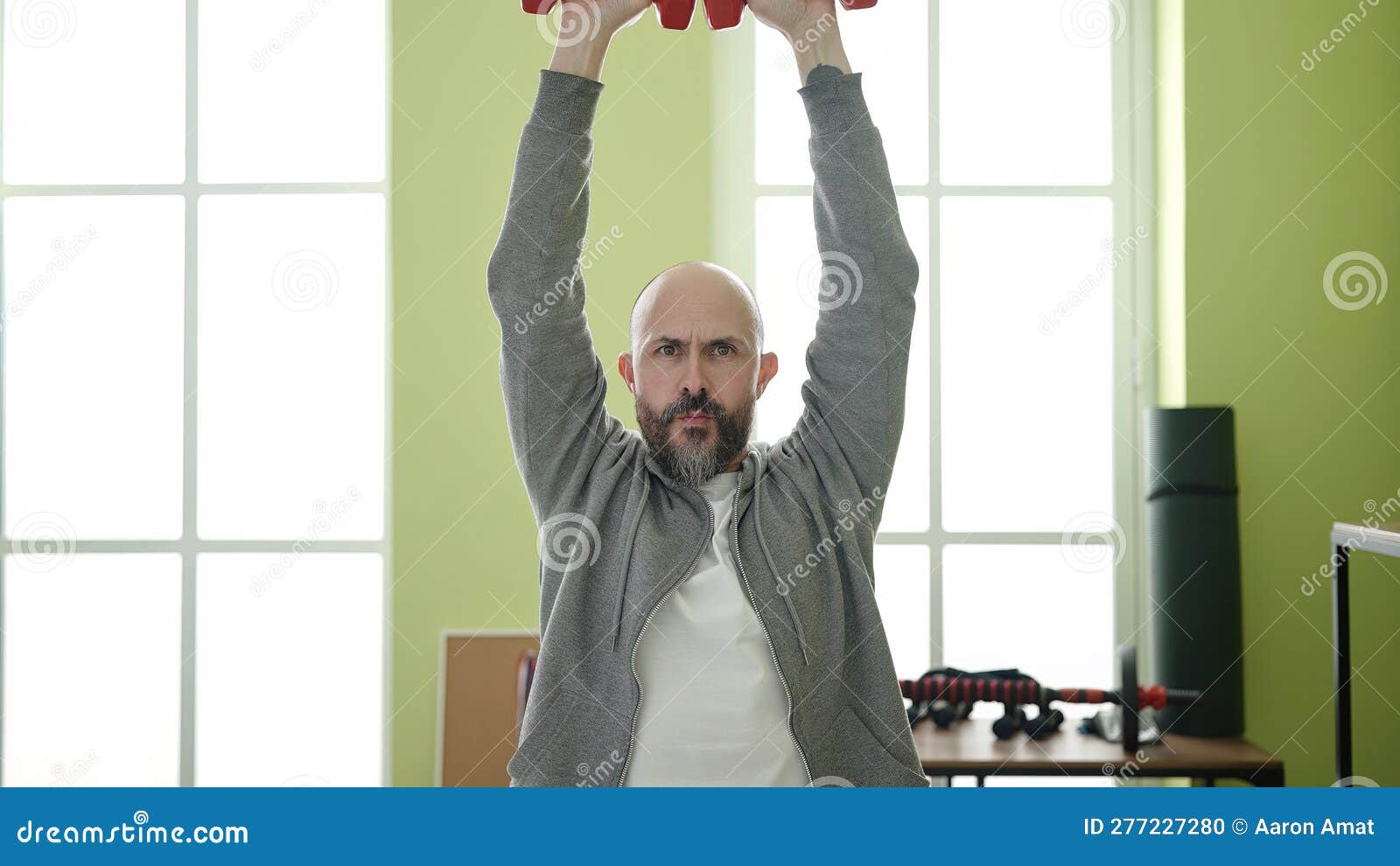 Young Bald Man Smiling Confident Using Dumbbells Training at Sport ...