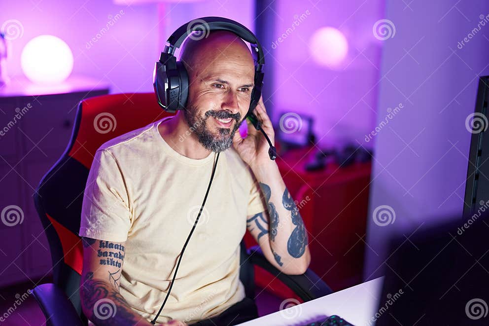 Young Bald Man Streamer Playing Video Game Using Computer at Gaming ...