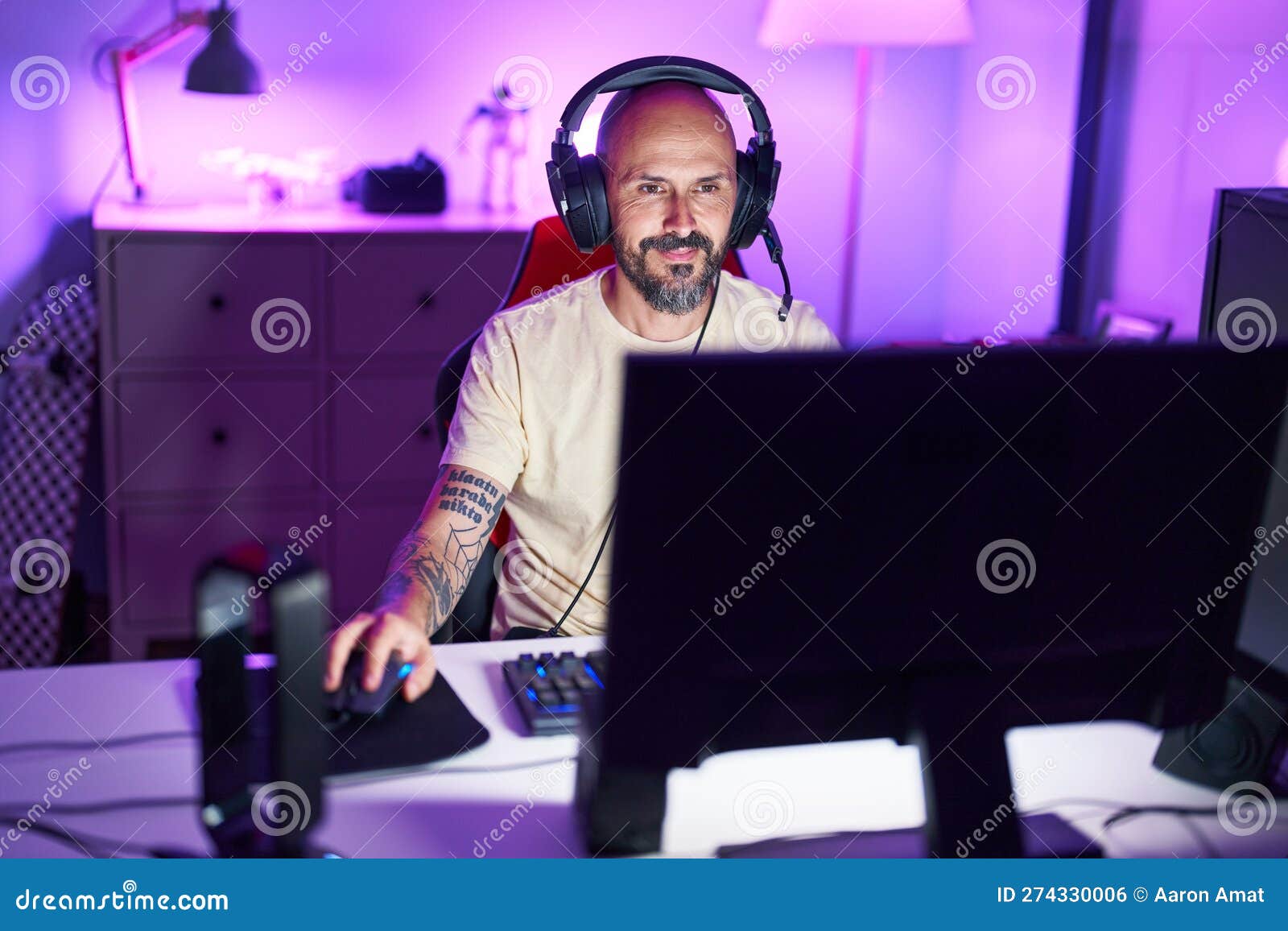 Young Bald Man Streamer Playing Video Game Using Computer at Gaming ...