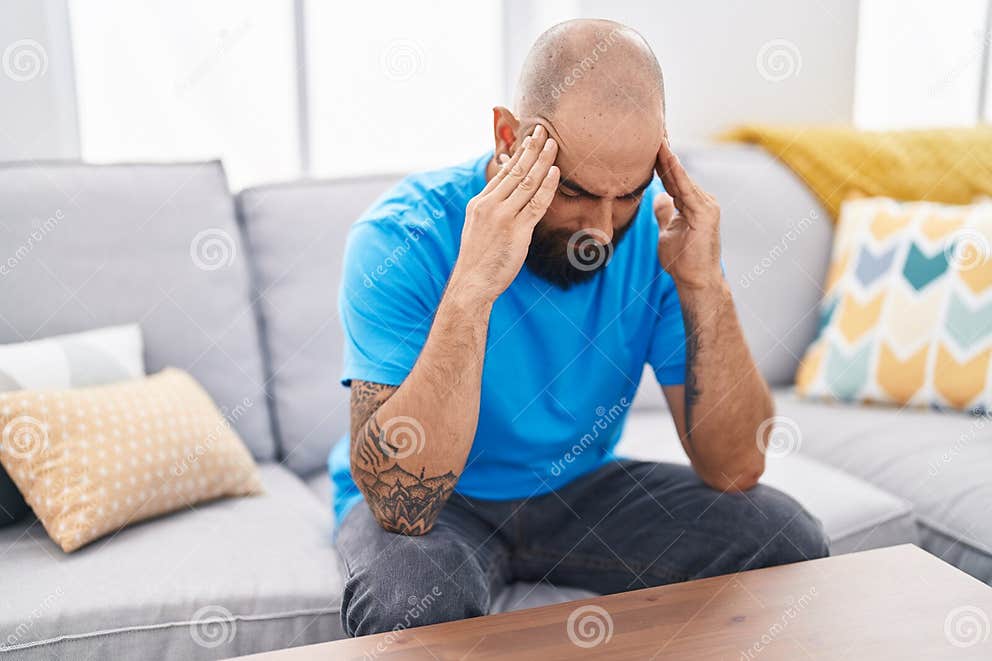 Young Bald Man Stressed Sitting on Sofa at Home Stock Image - Image of ...