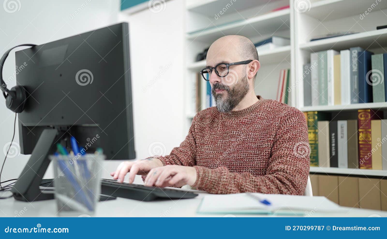 Young Bald Man Student Using Computer Studying at University Classroom ...