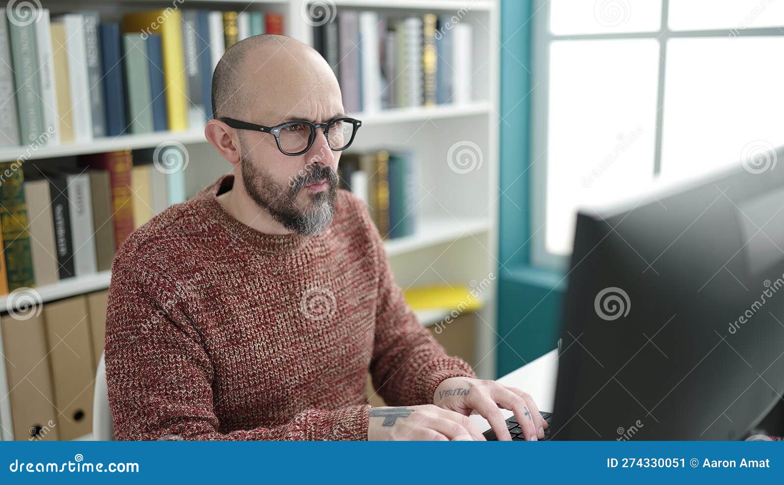 Young Bald Man Student Using Computer Studying at University Classroom ...
