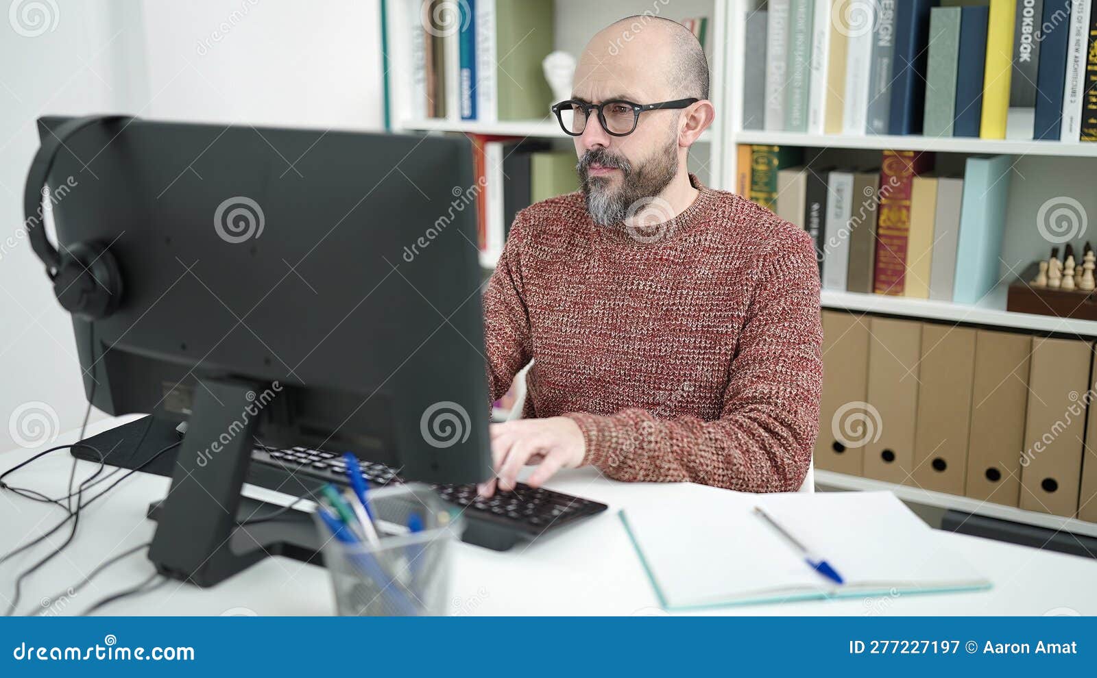 Young Bald Man Student Using Computer Studying at University Classroom ...