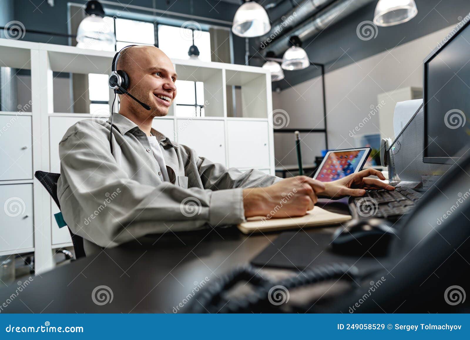 Young Bald Man Working in a Call Center Office Stock Image - Image of ...