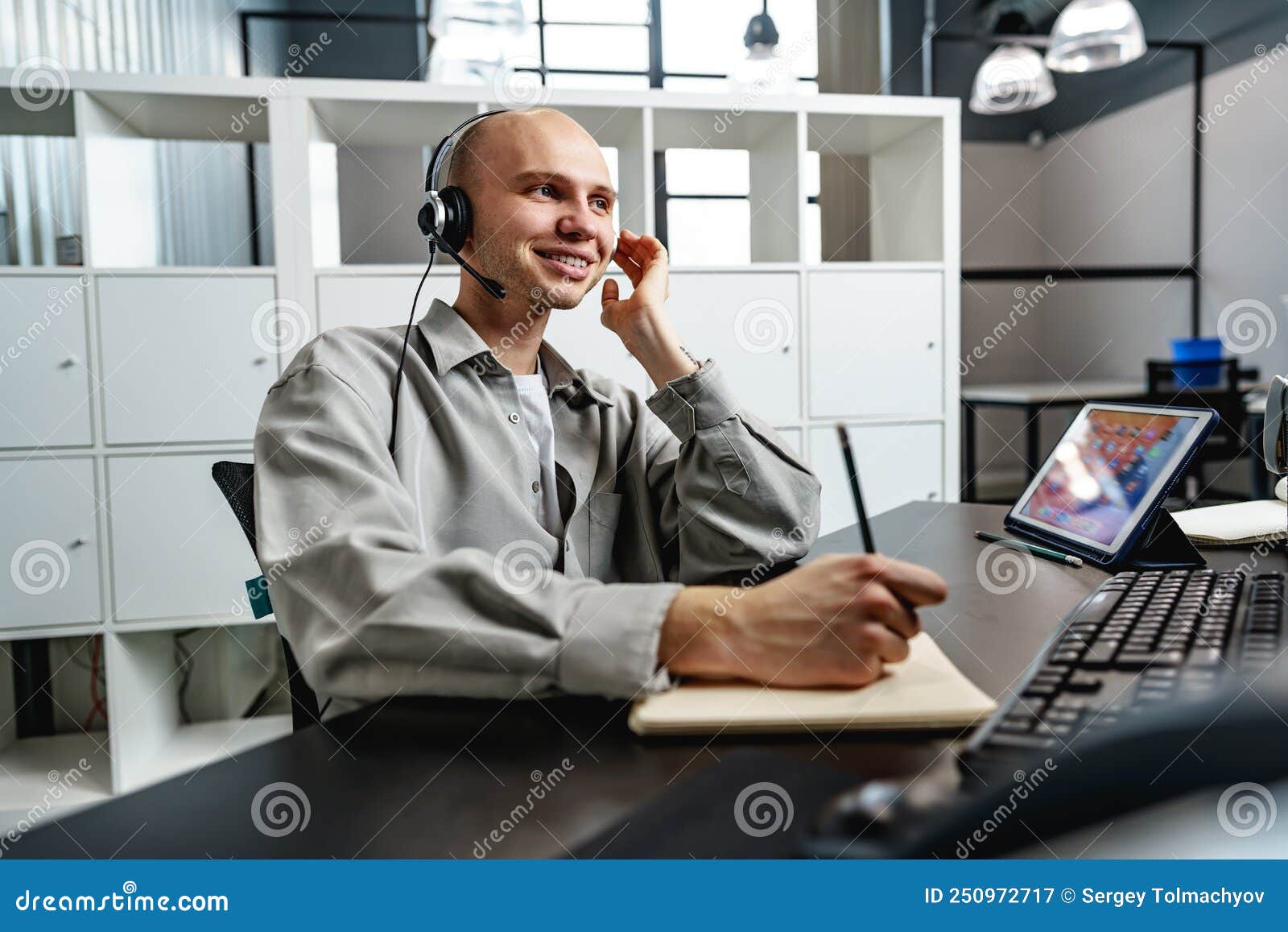 Young Bald Man Working in a Call Center Office Stock Image - Image of ...
