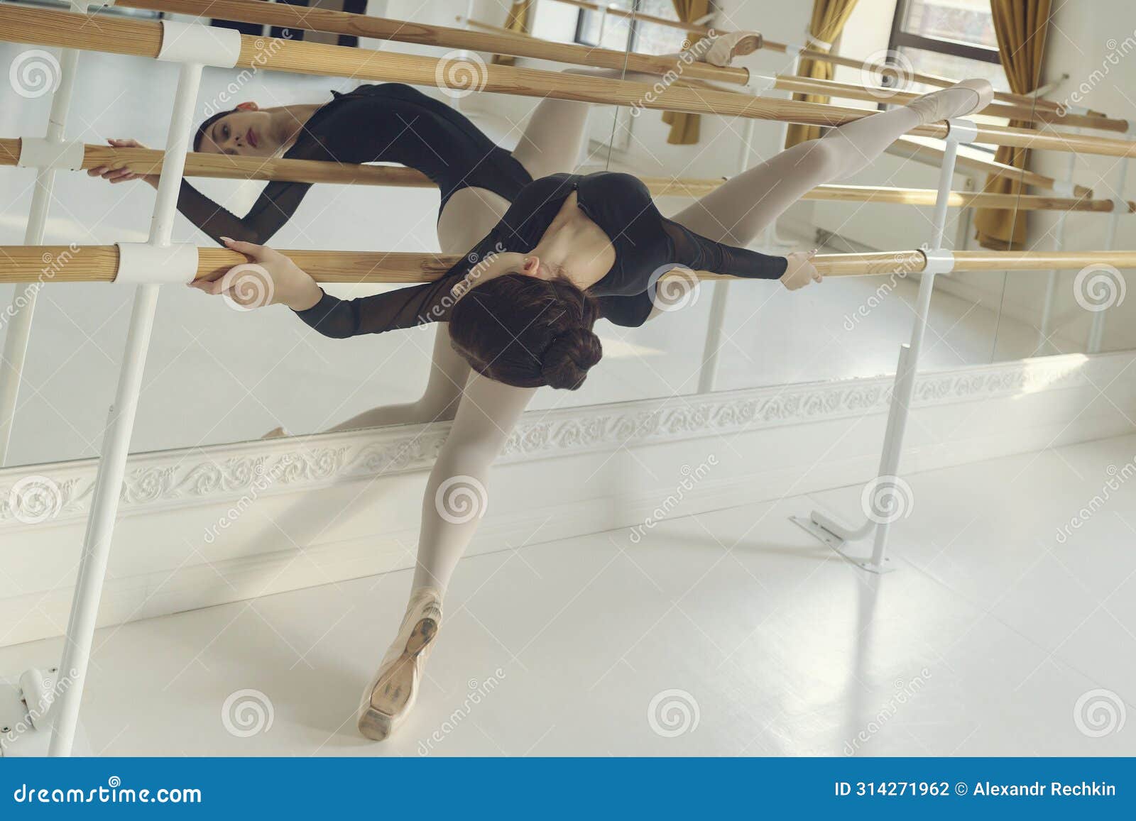 Young Ballerina in a Dance Class at a Ballet Machine Does Stretching ...