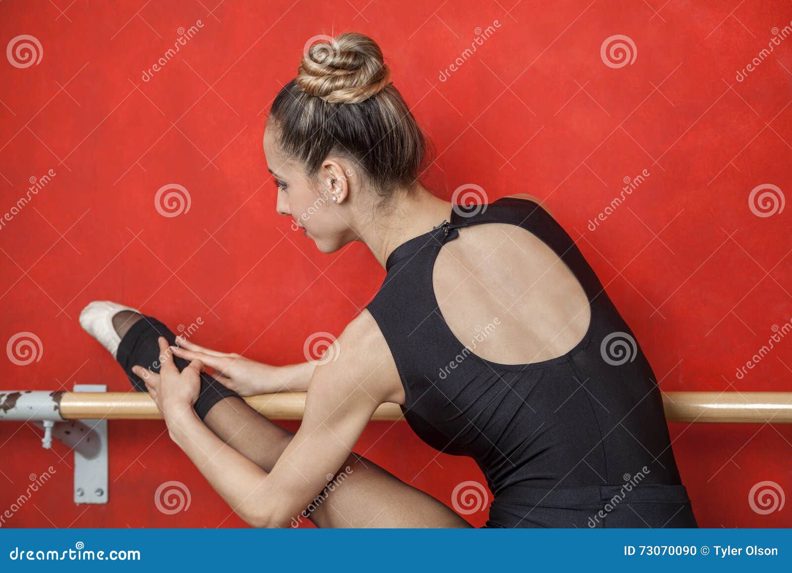 Young Ballerina with Leg on Bar in Dance Studio Stock Photo - Image of ...