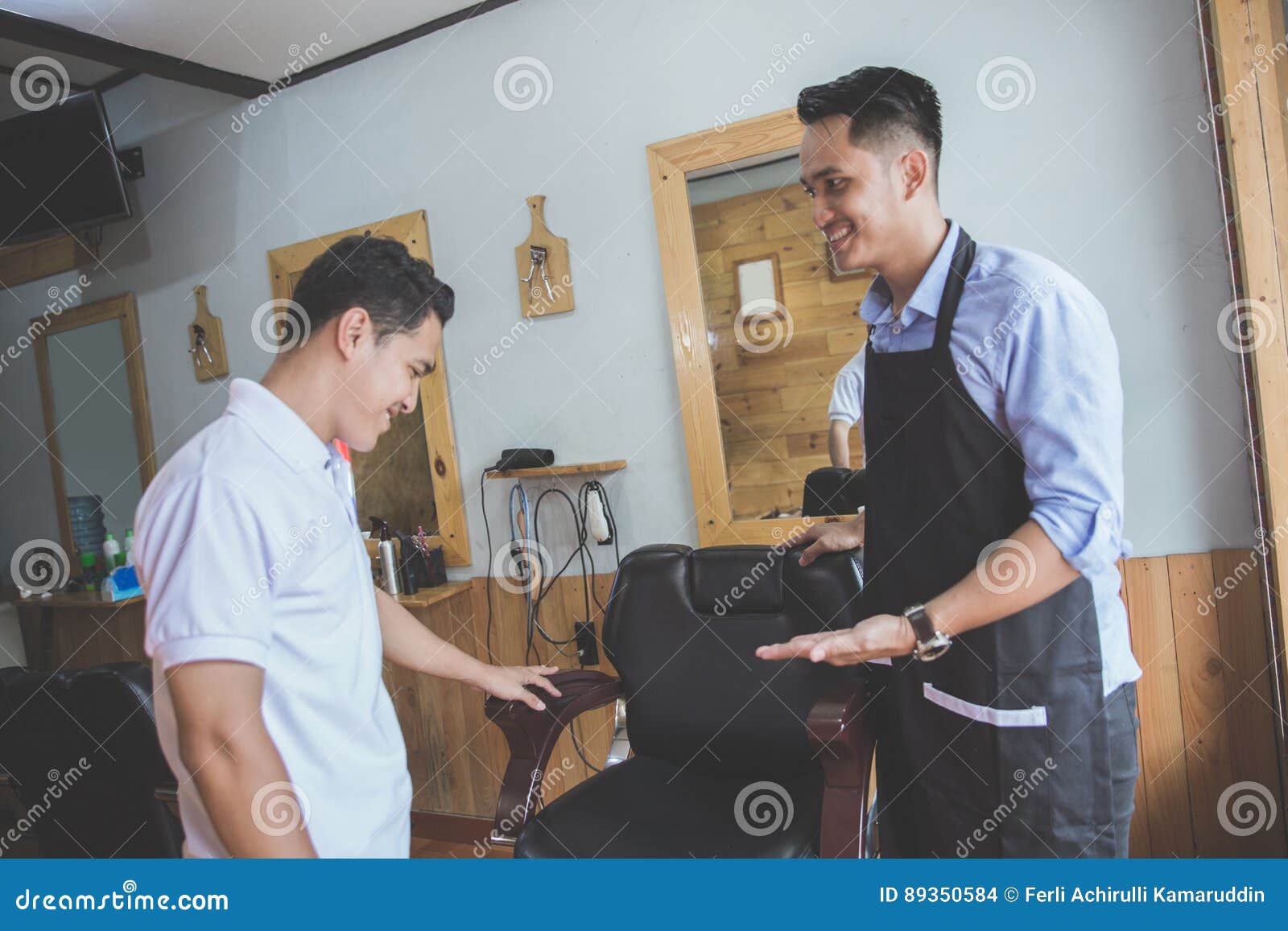 Young Barber Expert Smiling Welcoming Customer To His Barbershop Stock ... Young Barber Expert Smiling Welcoming Customer To His Barbershop Stock ...