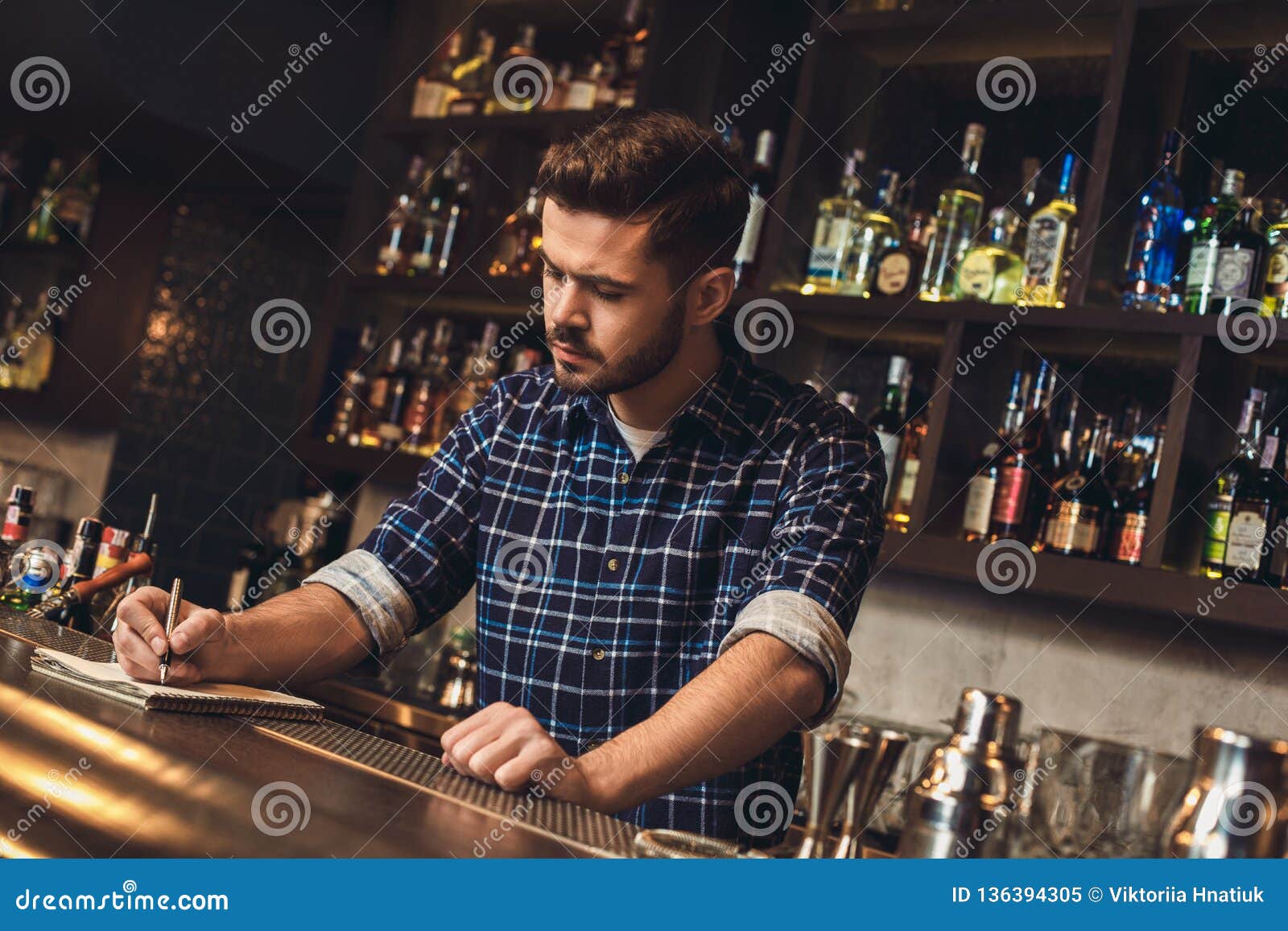 Young Bartender Standing at Bar Counter Writing Receipt Concentrated ...