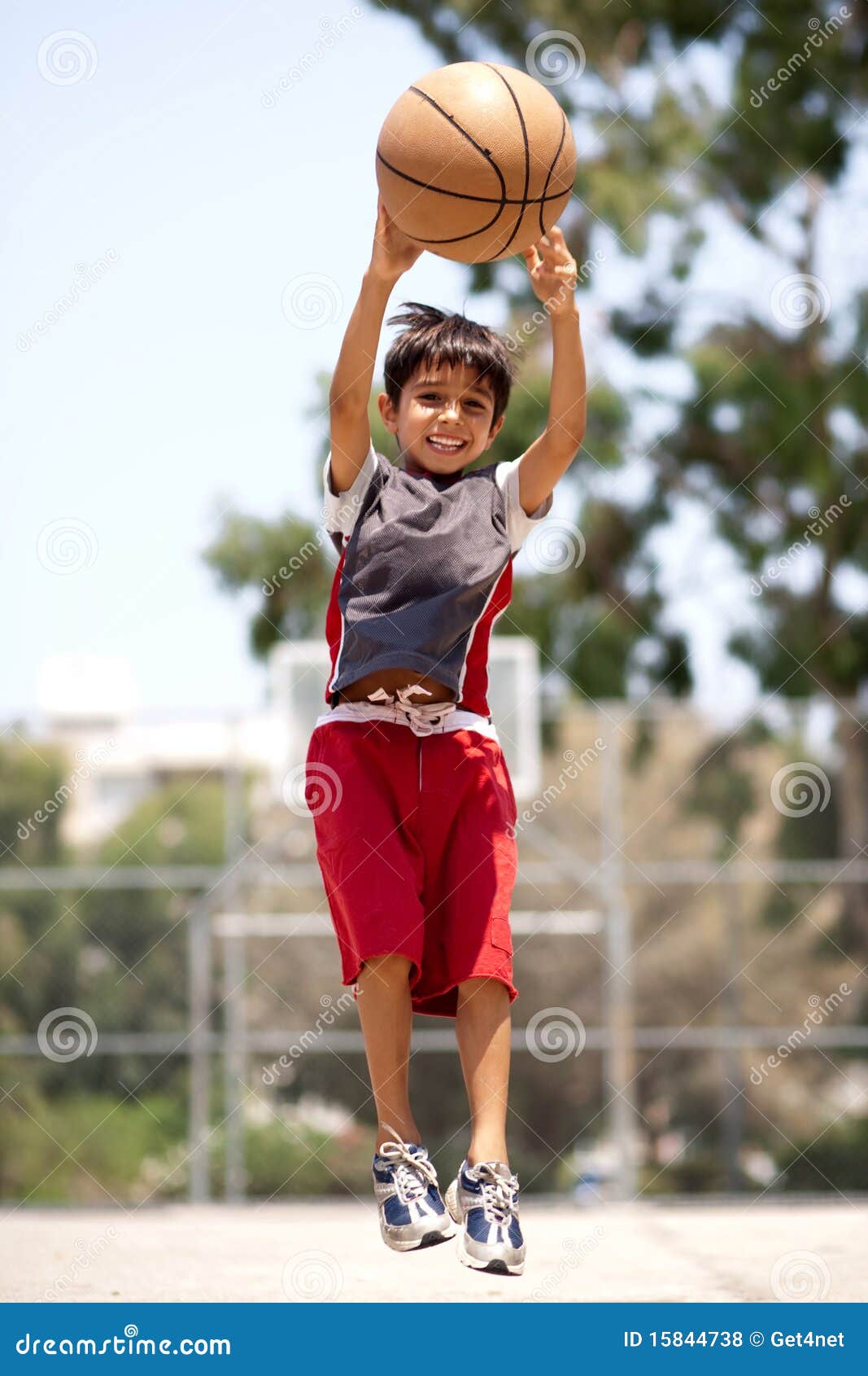 Young Basketball Player Jumping High Stock Photo - Image of player ...