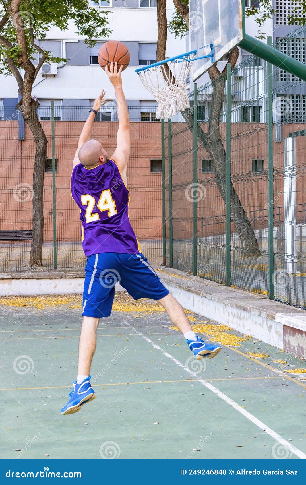 A Young Basketball Player Shooting a Basketball Stock Photo - Image of ...