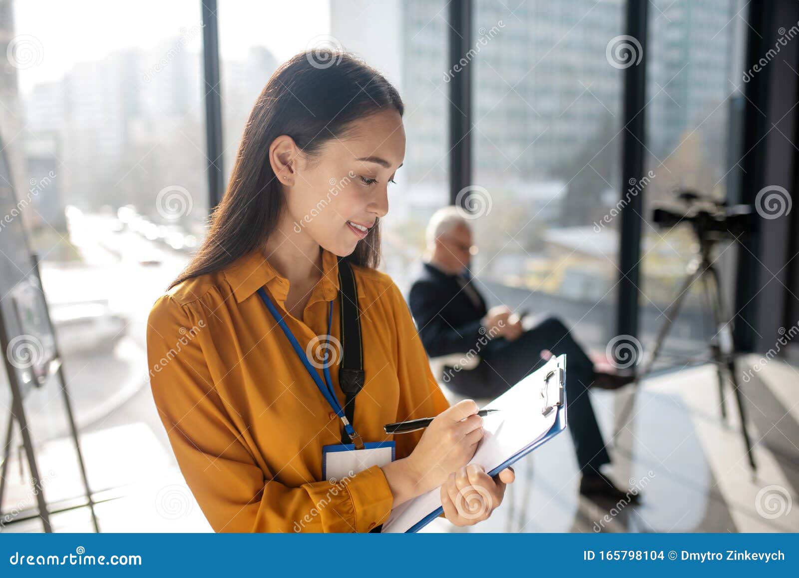 Young Beaming Pretty Asian Reporter Making Notes Stock Photo - Image of ...