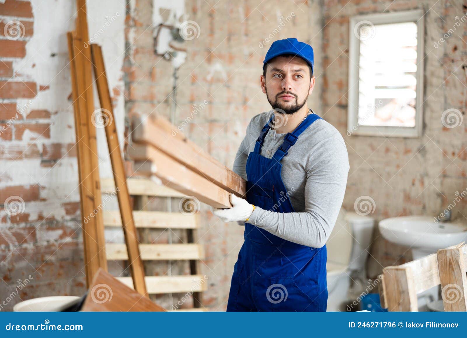 Young Bearded Builder Arranging Timber in Building Under Renovation ...