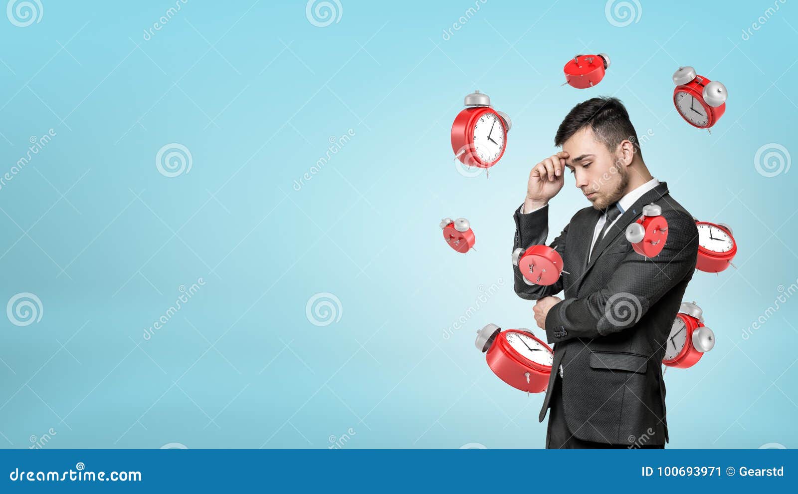 A Young Bearded Businessman Deep In Thought While Many Red Retro Alarm