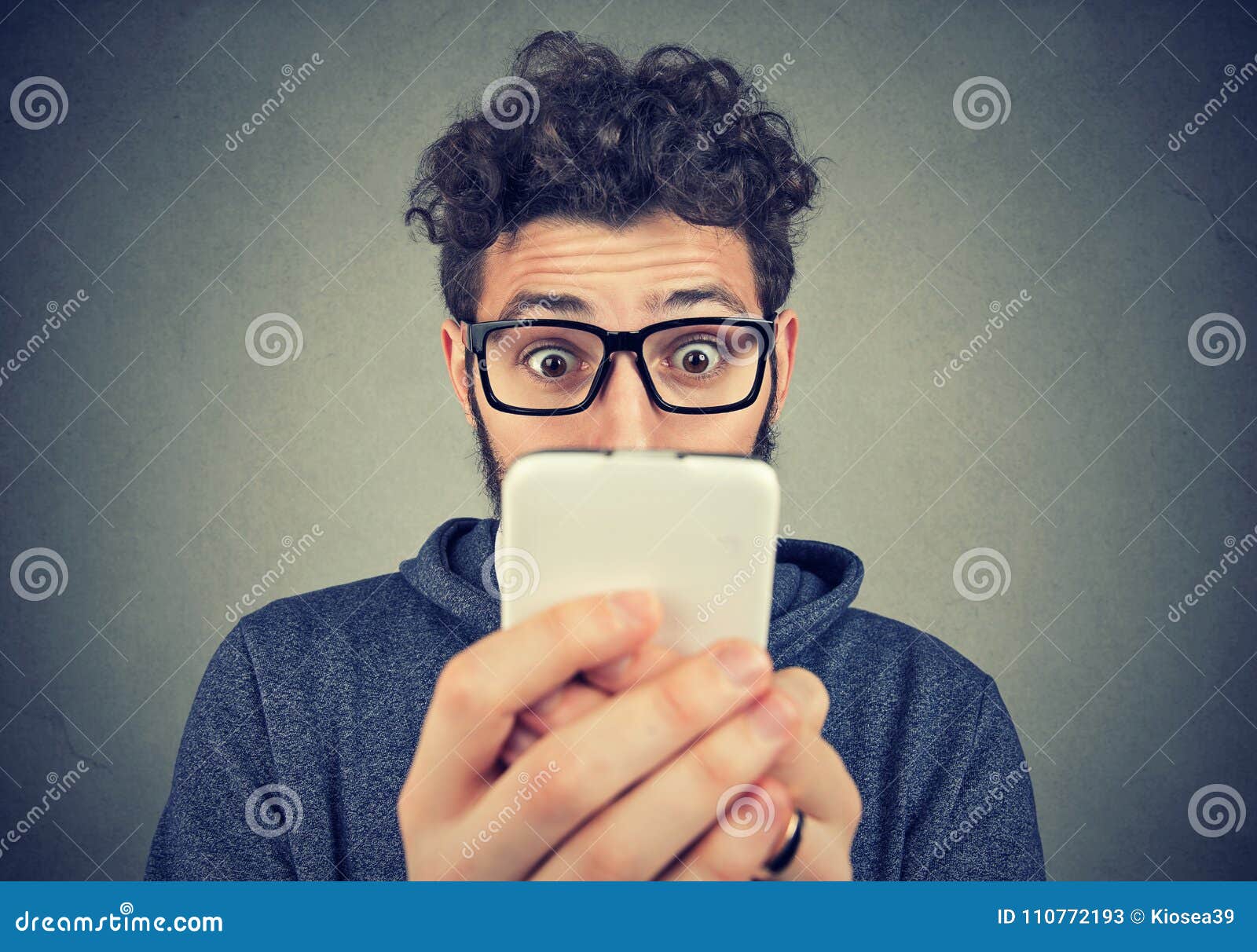 Shocked Young Man Looking at Smartphone Stock Image - Image of ...