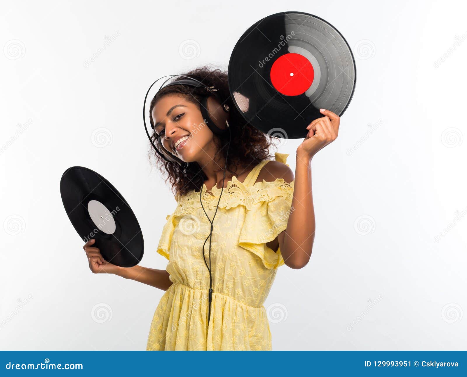 Young Beautiful African American Woman With Headphones In Yellow Dress