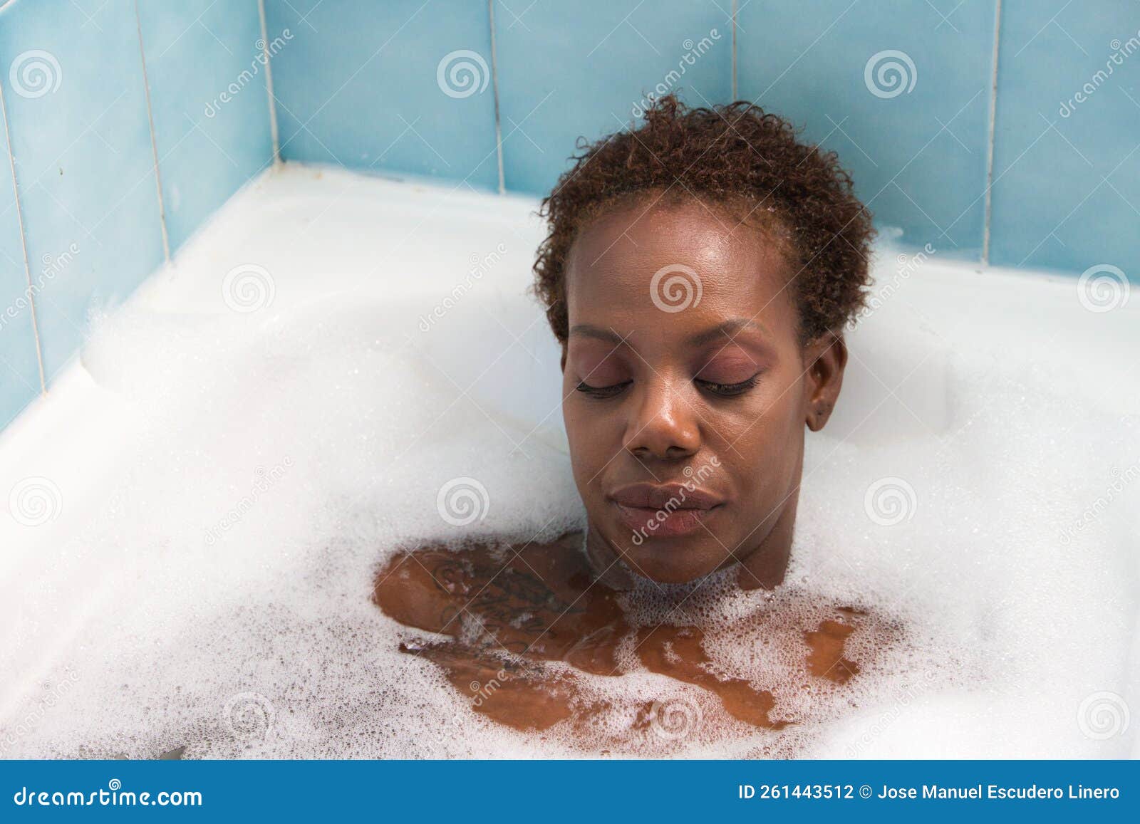 Young And Beautiful Afro American Woman Takes A Bubble Bath In The