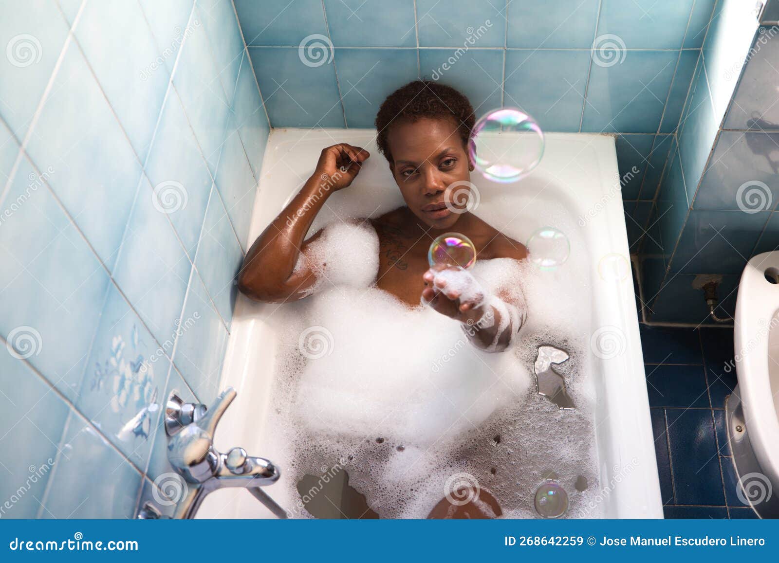 Young And Beautiful Afro American Woman Takes A Bubble Bath In The