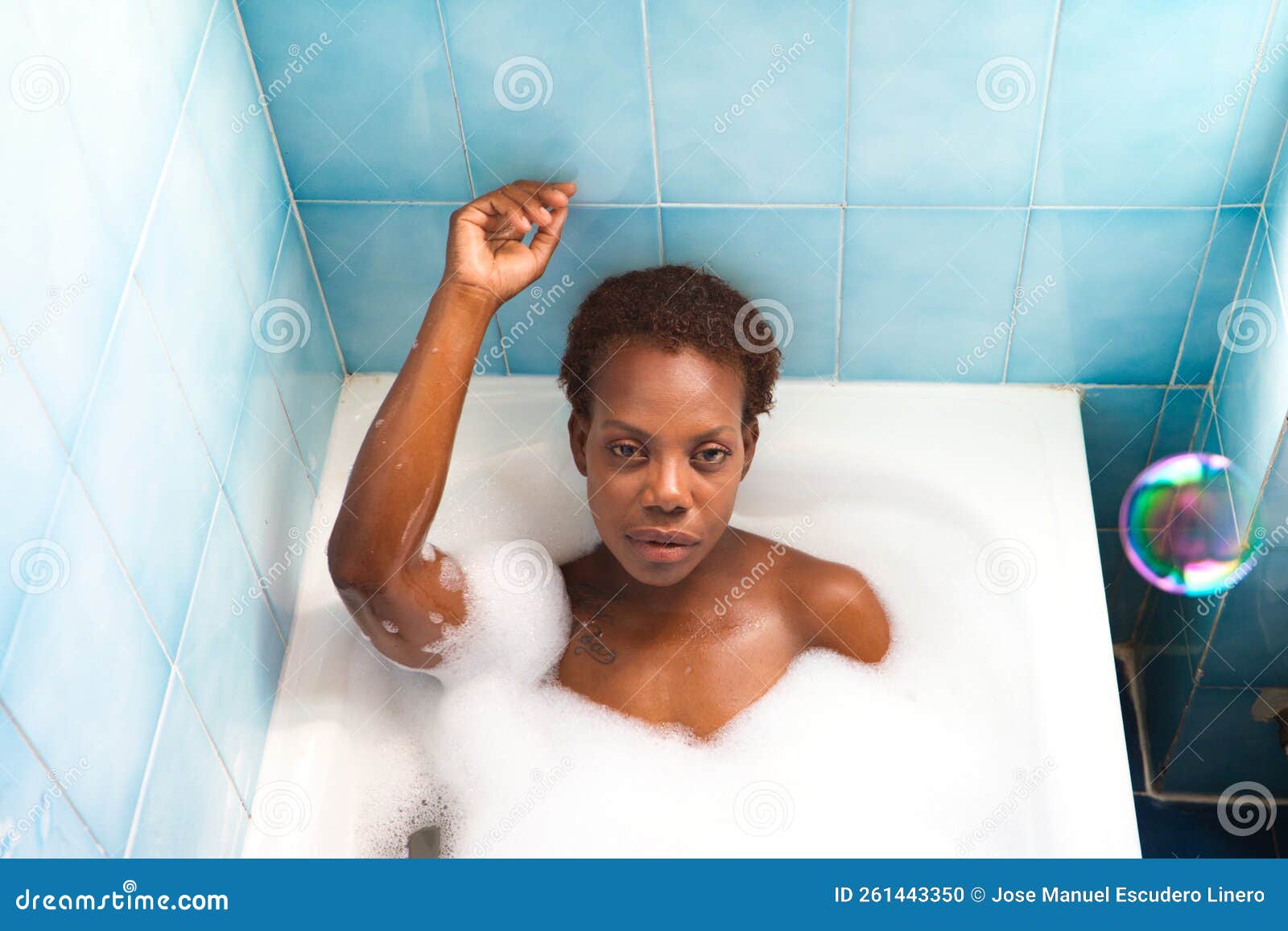 Young And Beautiful Afro American Woman Takes A Bubble Bath In The