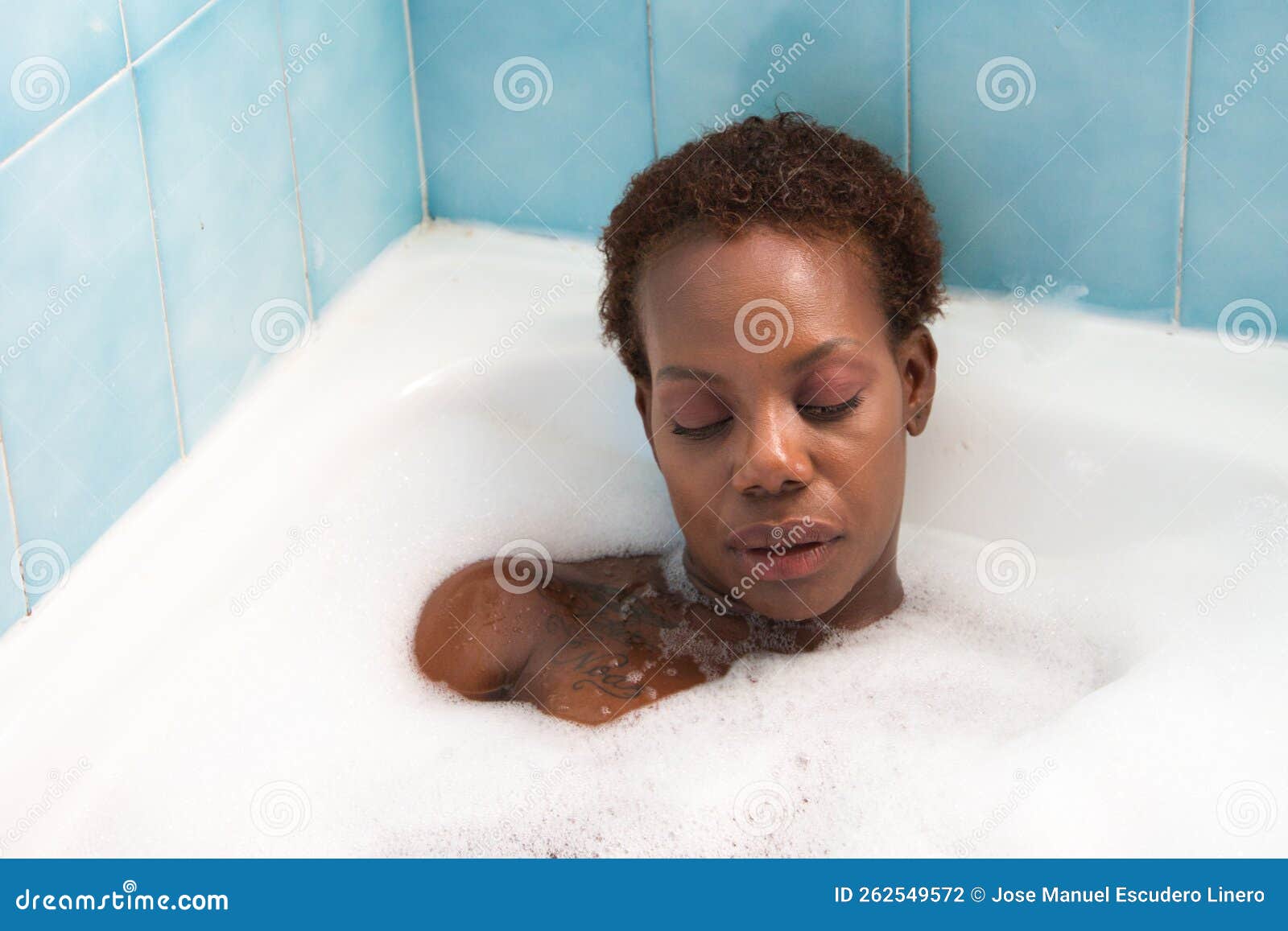 Young And Beautiful Afro American Woman Takes A Bubble Bath In The