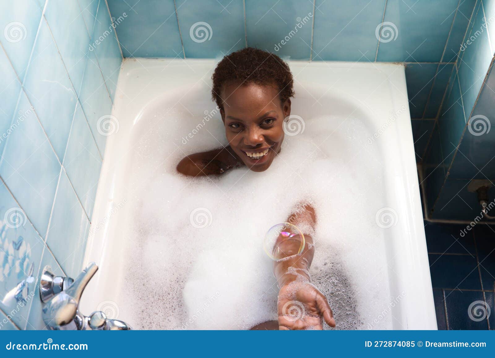Young And Beautiful Afro American Woman Takes A Bubble Bath In The