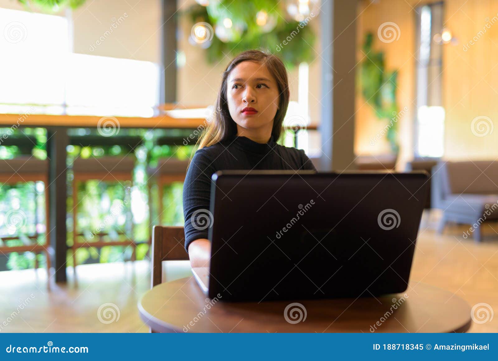 Young Beautiful Asian Businesswoman with Laptop Thinking and Sitting at ... Young Beautiful Asian Businesswoman with Laptop Thinking and Sitting at ...