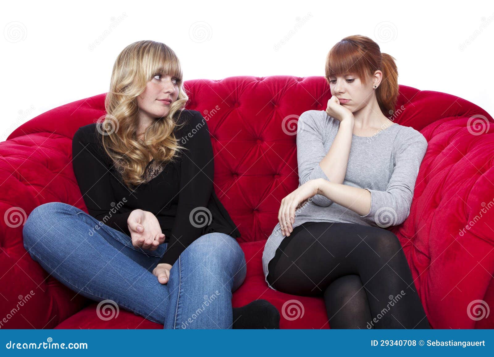 Young Beautiful Blond and Red Haired Girls on Red Sofa are Bored Stock ...