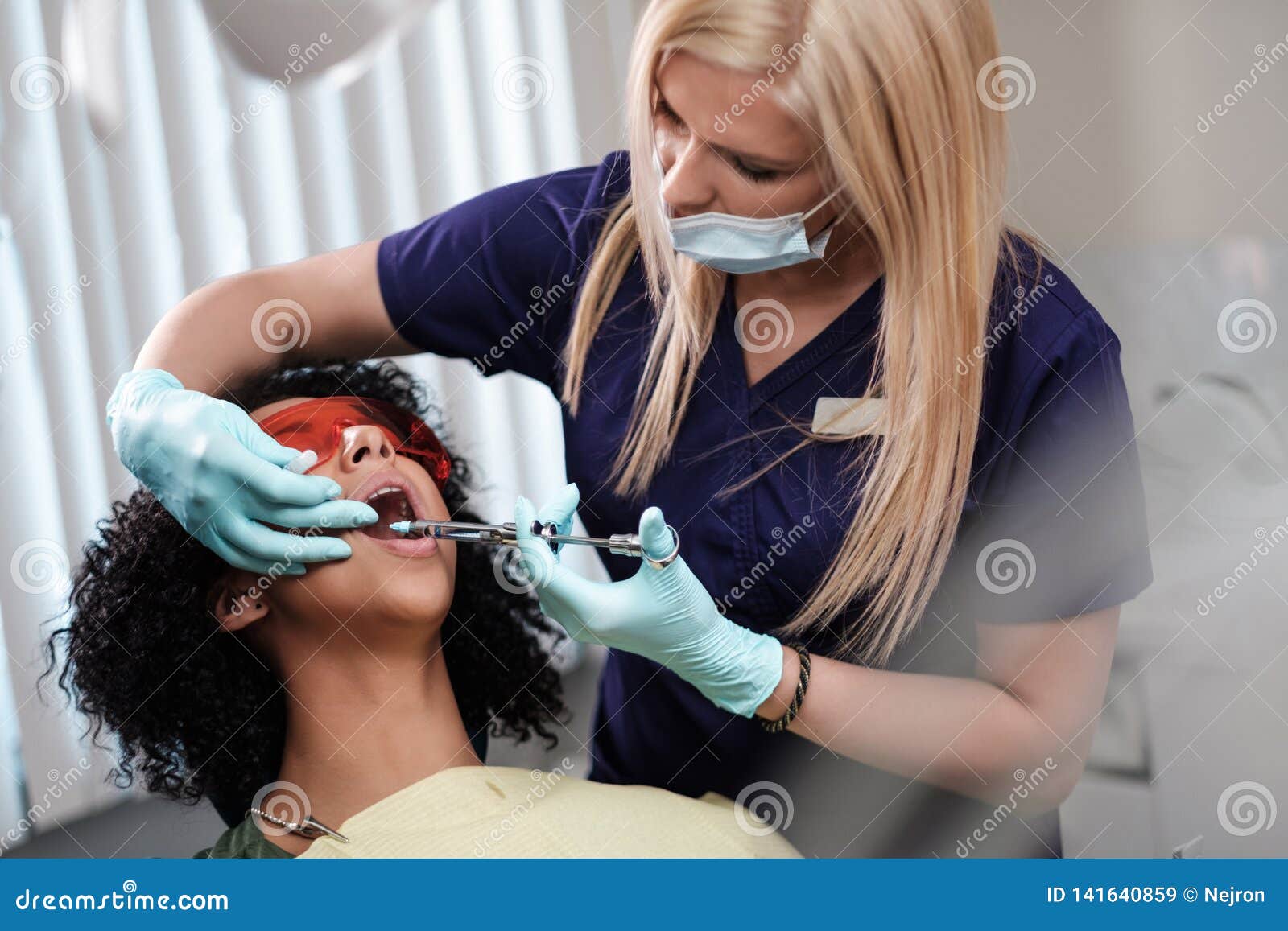 Young Beautiful Blond Woman Dentist At Dentist`s Surgery Stock Image